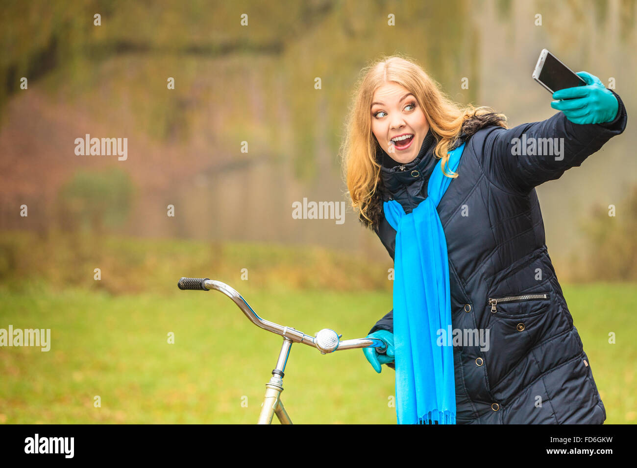 Happy active young woman girl with bike bicycle in fall autumn park ...