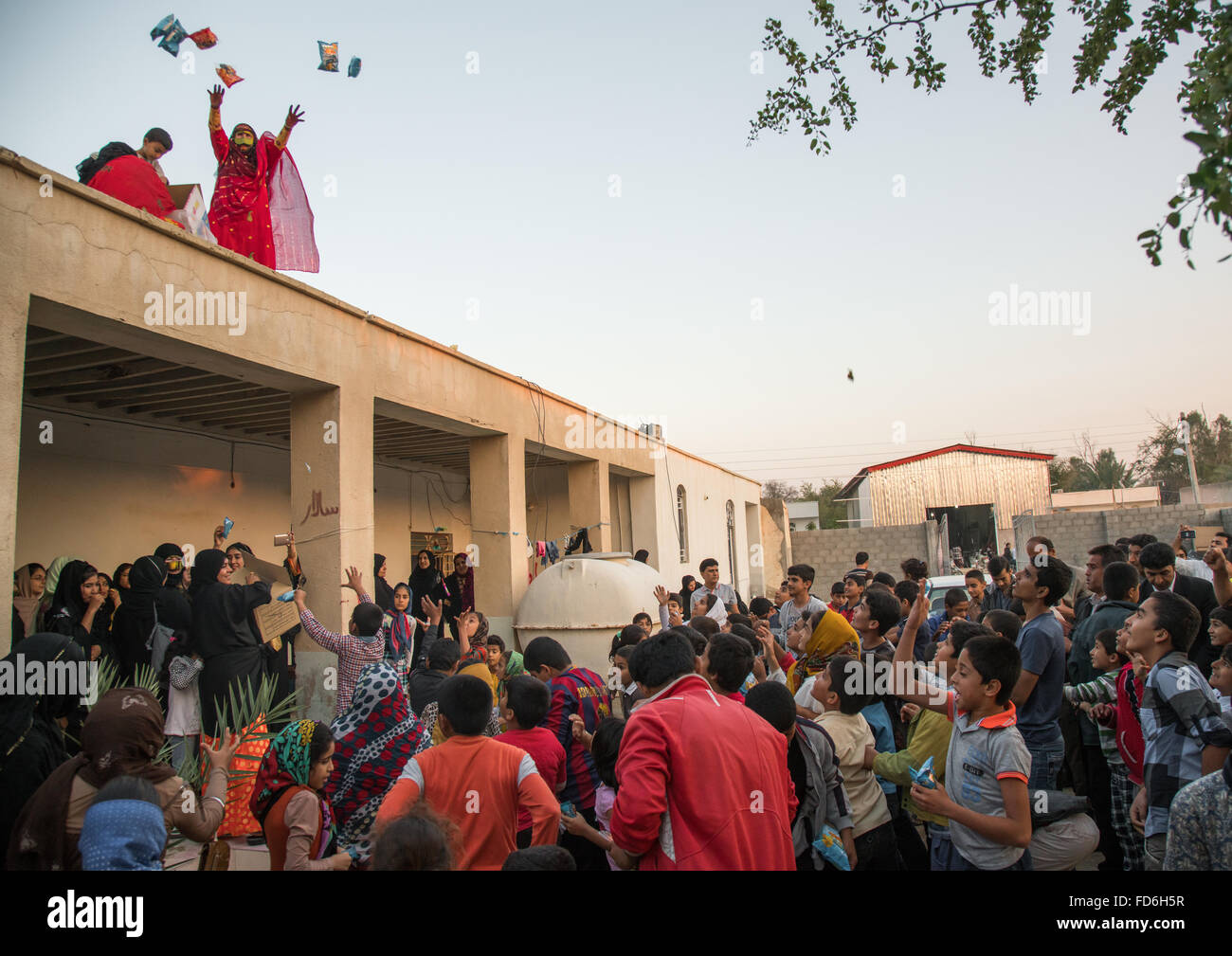 women with face masks throwing sweets to kids during a wedding ...
