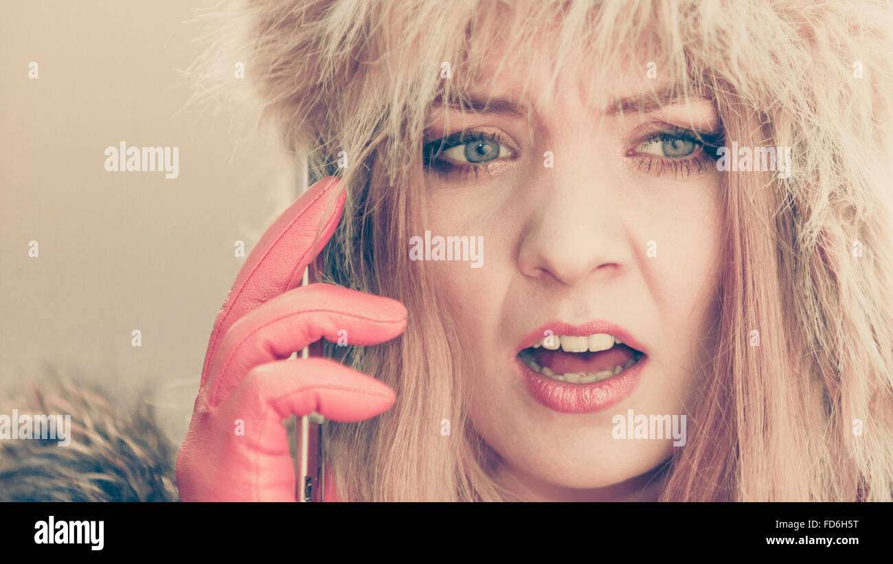 Portrait of scared afraid pretty woman talking on mobile phone ...