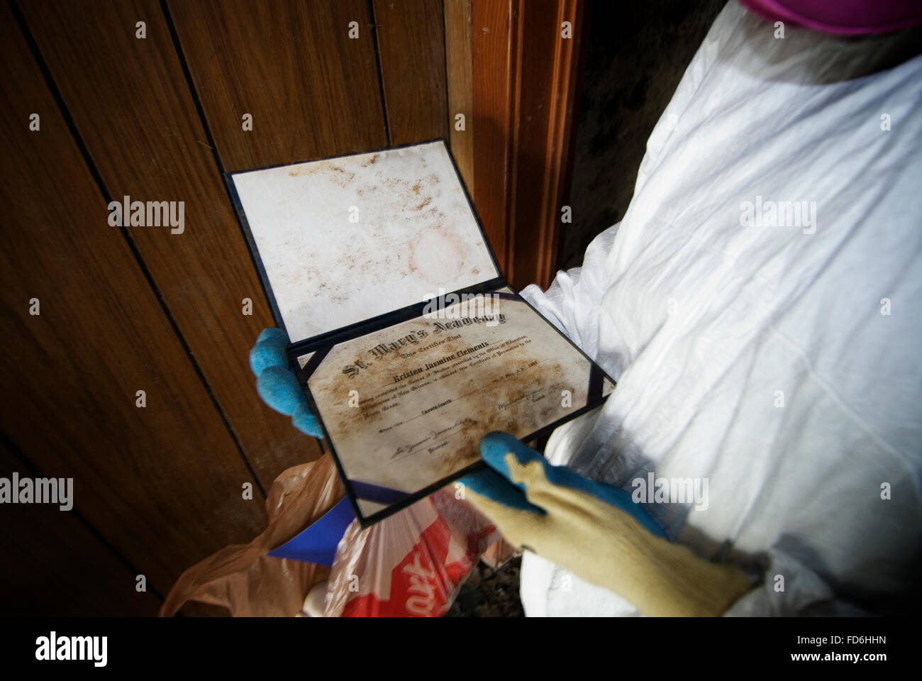 Volunteers in full protective gear strip heavily molded drywall and ...