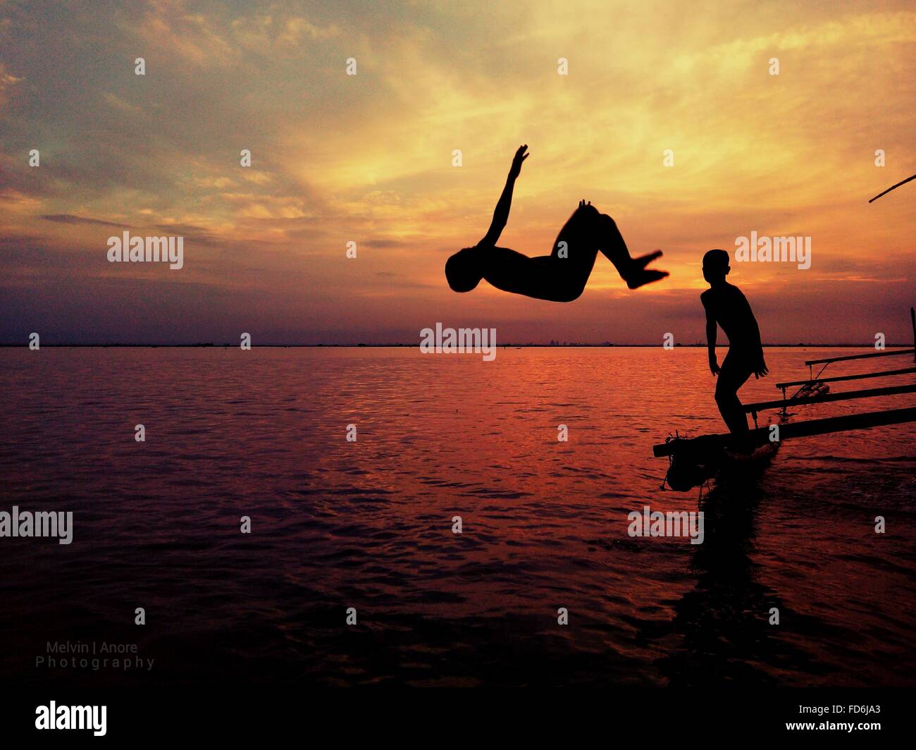 Children jumping into water silhouette hi-res stock photography and ...