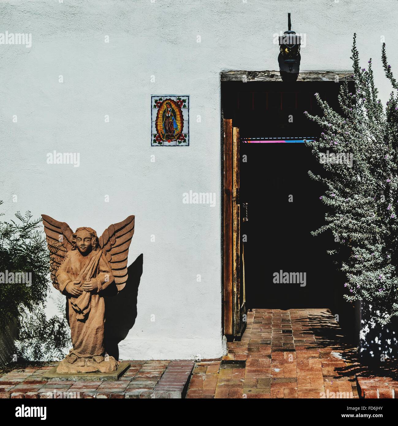 Angel Statue Against Wall By Doorway Stock Photo - Alamy