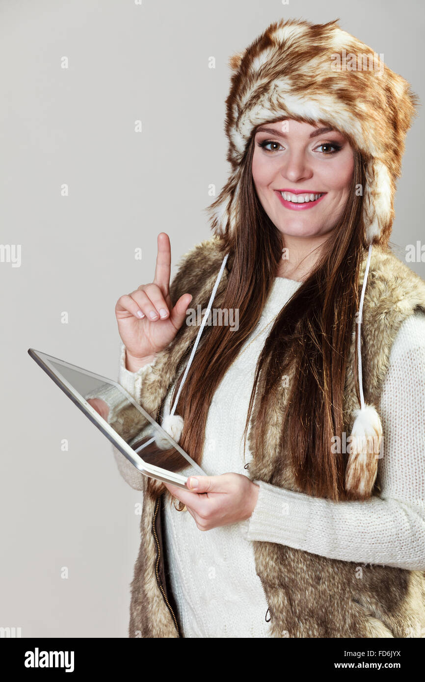Technology and Internet concept. Young pretty woman in winter clothes ...