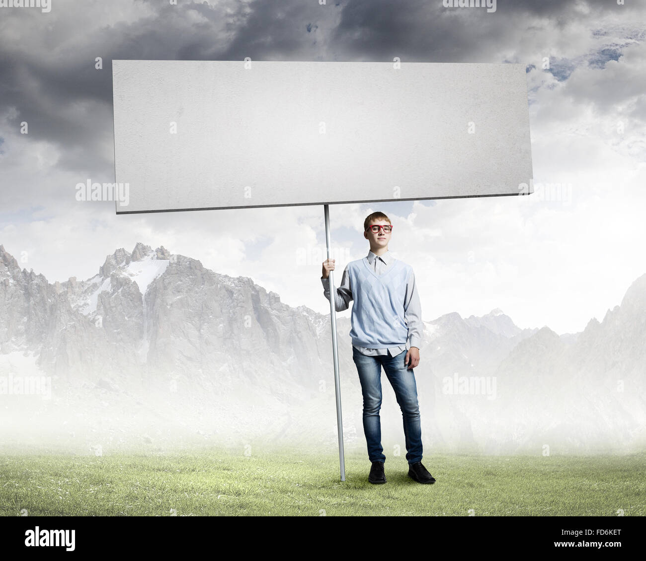 Young man in glasses holding blank banner. Place for text Stock Photo ...