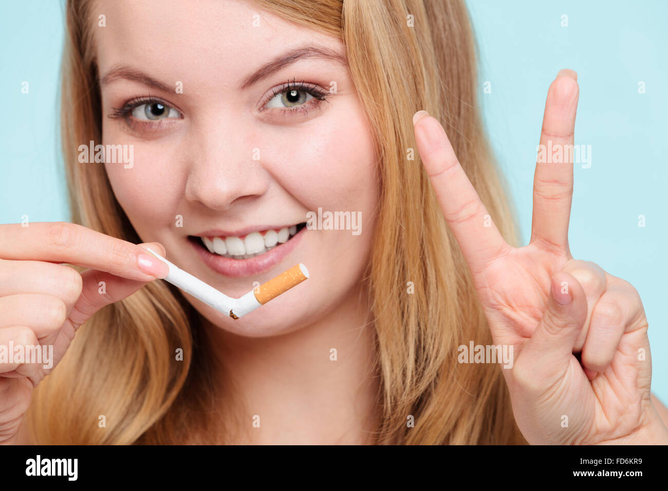 Smilling pretty girl breake down cigarette. Winning with addicted ...