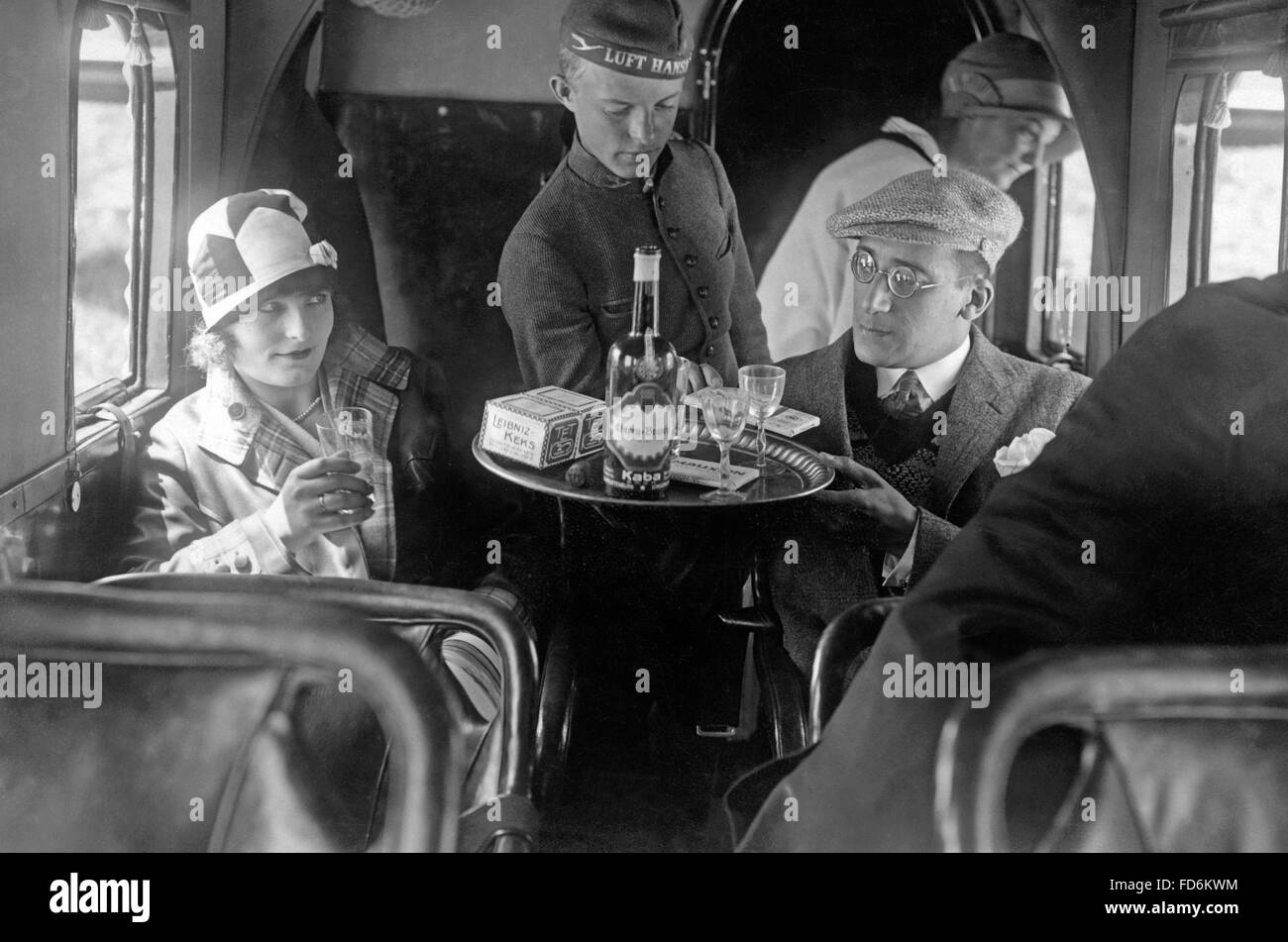 A member of the Lufthansa air crew with passengers, 1926 Stock Photo ...