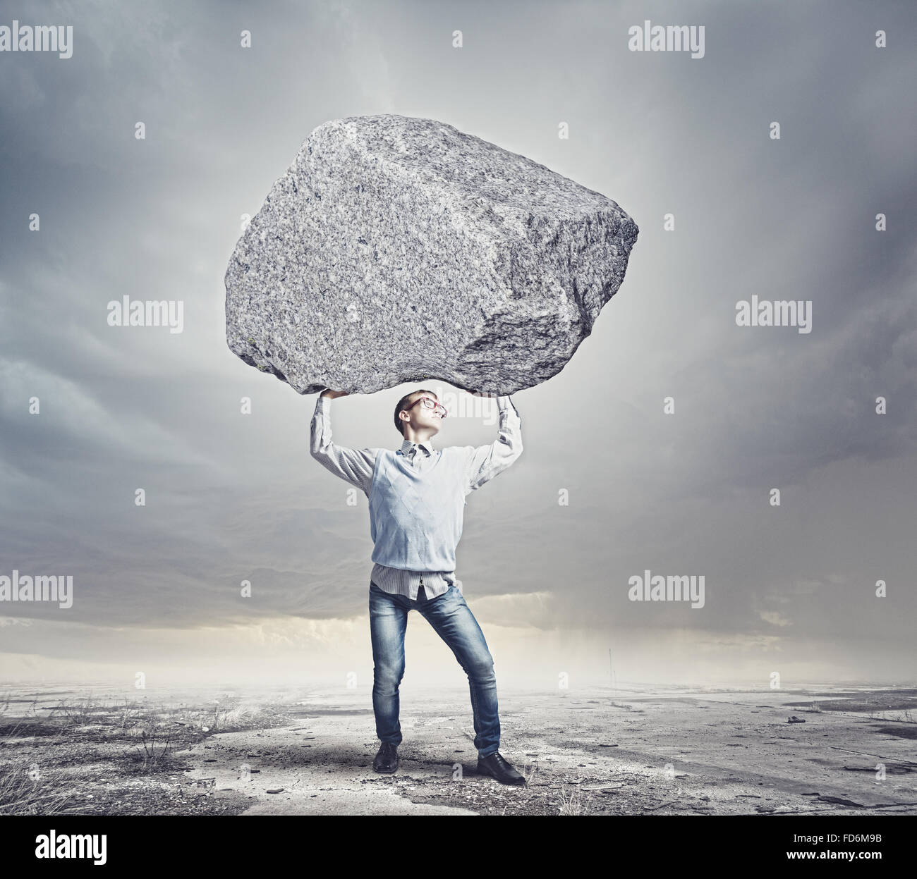 Young strong man holding huge stone above head Stock Photo - Alamy