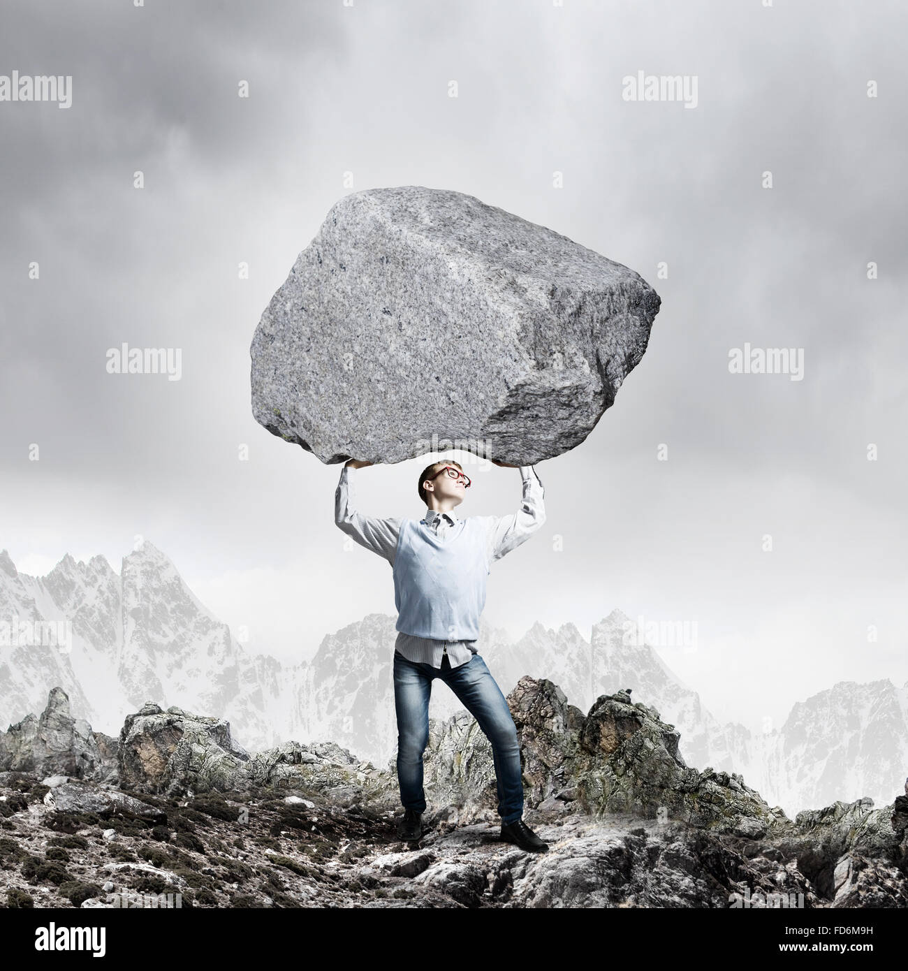 Young strong man holding huge stone above head Stock Photo - Alamy