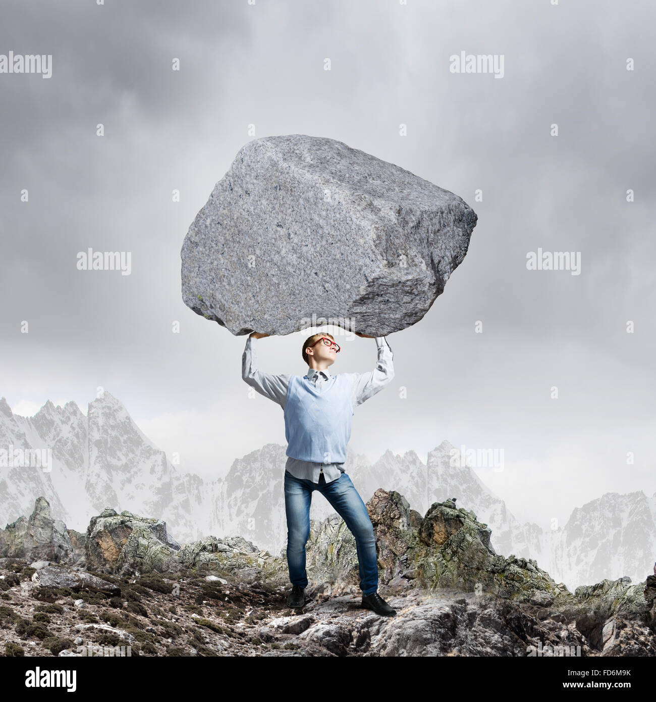 Man holding rock above head hi-res stock photography and images - Alamy