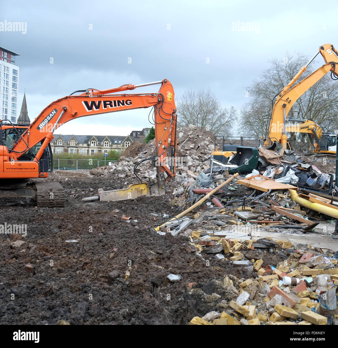 Demolition machines at work in the city of Cardiff, regenerating the ...