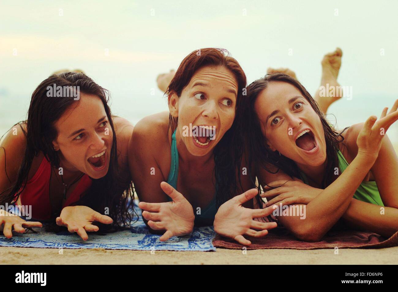 Portrait Of Happy Friends Relaxing On Beach Stock Photo - Alamy