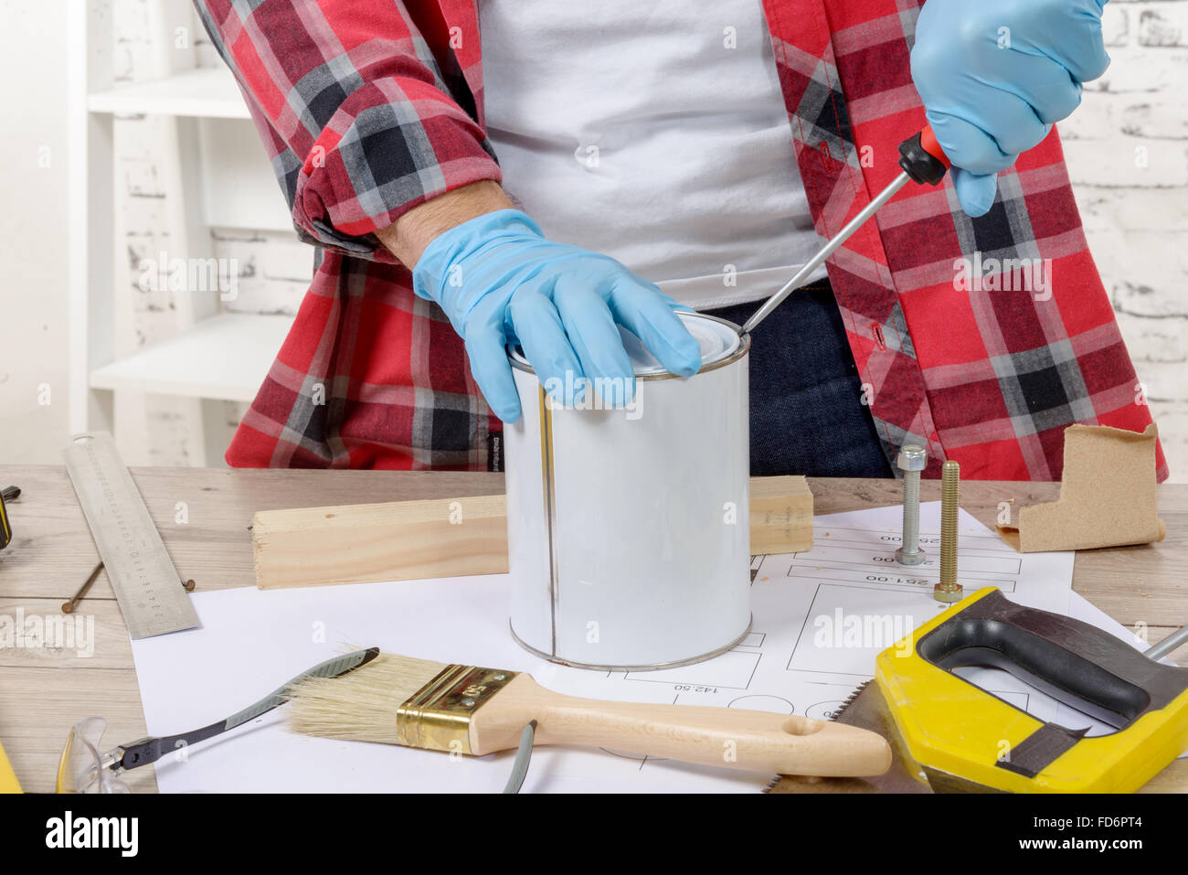 a house painter opens a can of paint with a screwdriver Stock Photo - Alamy
