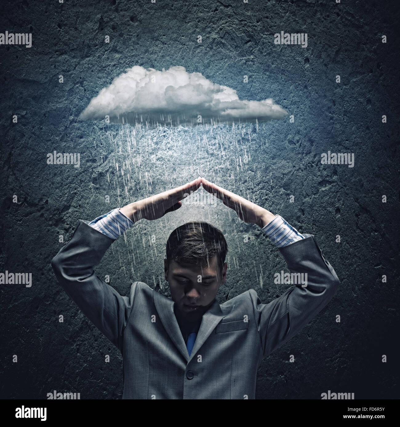 Businessman sitting under rain protecting head with arms Stock Photo ...