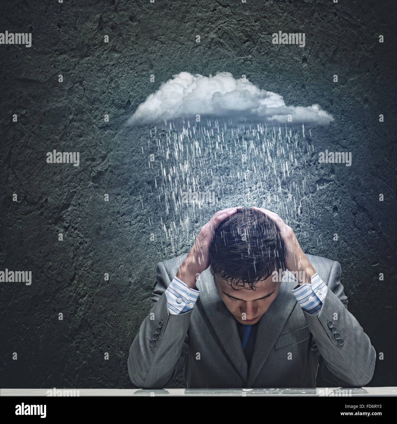 Depressed young businessman sitting wet under rain Stock Photo - Alamy