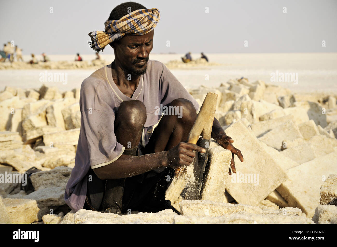 Afar worker extracting salt from lake Assale, Danakil depression, Afar ...