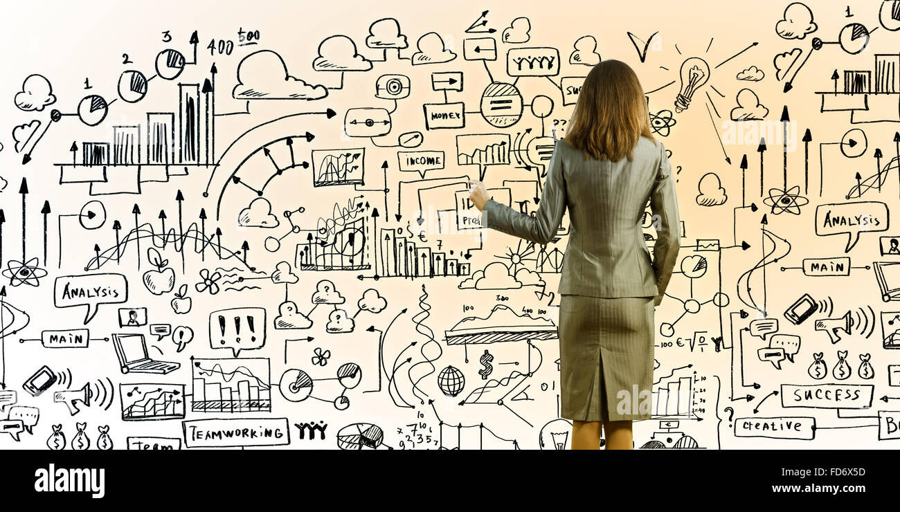 Back view of businesswoman drawing business strategy sketch Stock Photo ...
