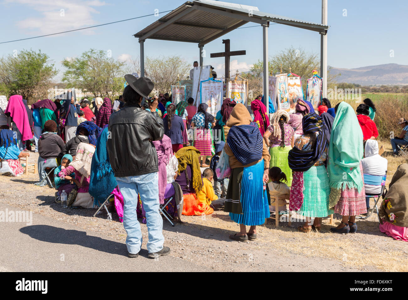 Indigenous pilgrims listen to an outdoor mass on the pilgrimage route ...