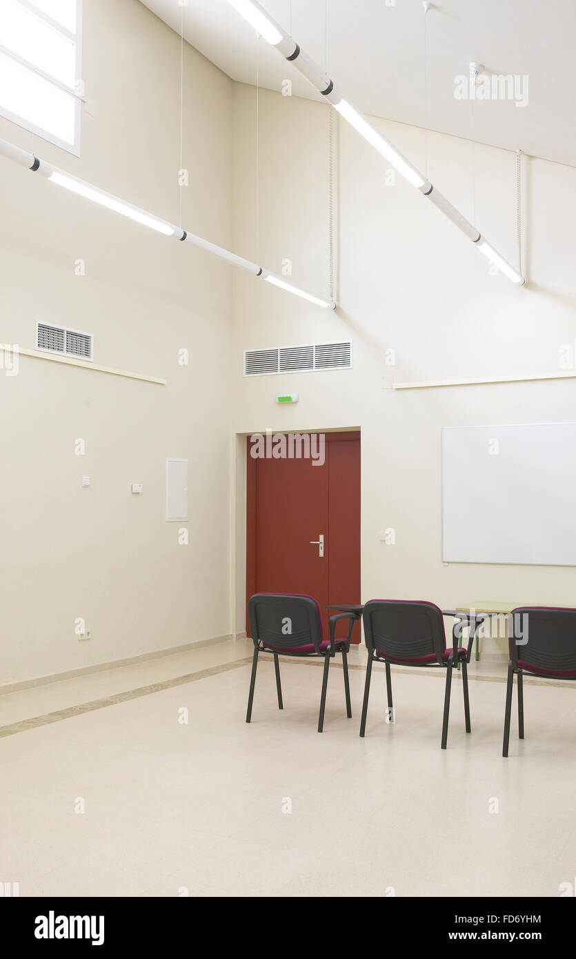 Interior classroom with white walls with chairs. Vertical Stock Photo ...