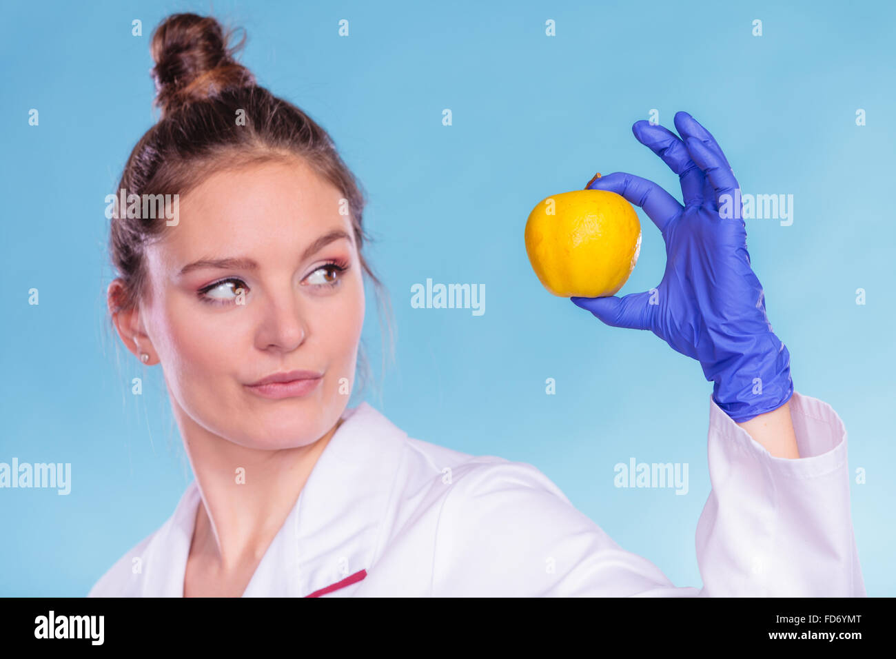 Scientist doctor with rotten apple. Woman chemist holding genetically ...