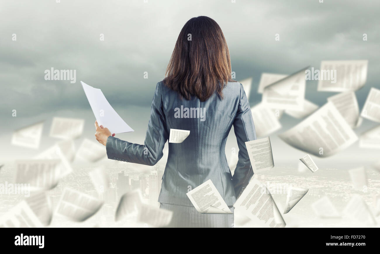 Back view of businesswoman holding papers in hands Stock Photo - Alamy