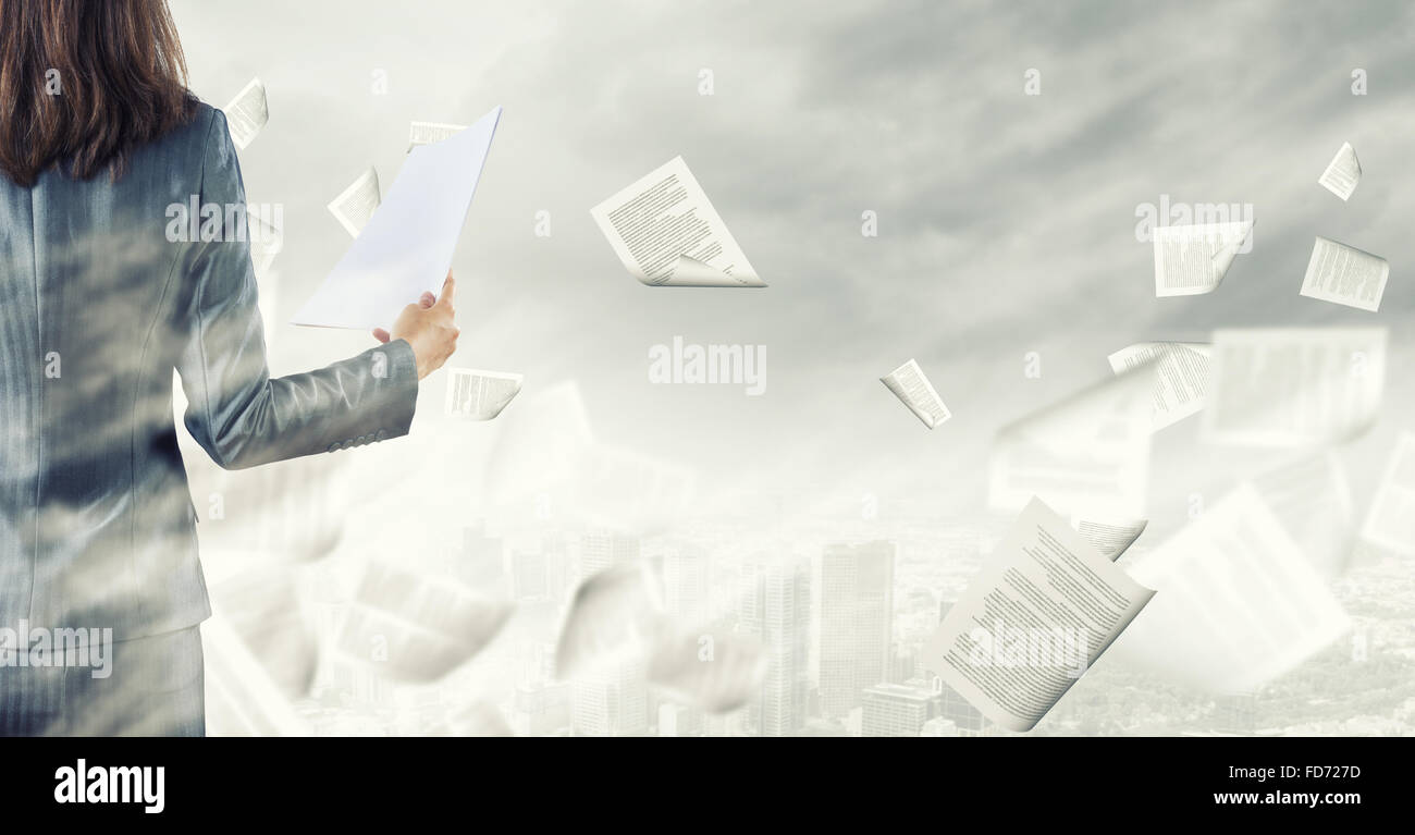 Back view of businesswoman holding papers in hands Stock Photo - Alamy