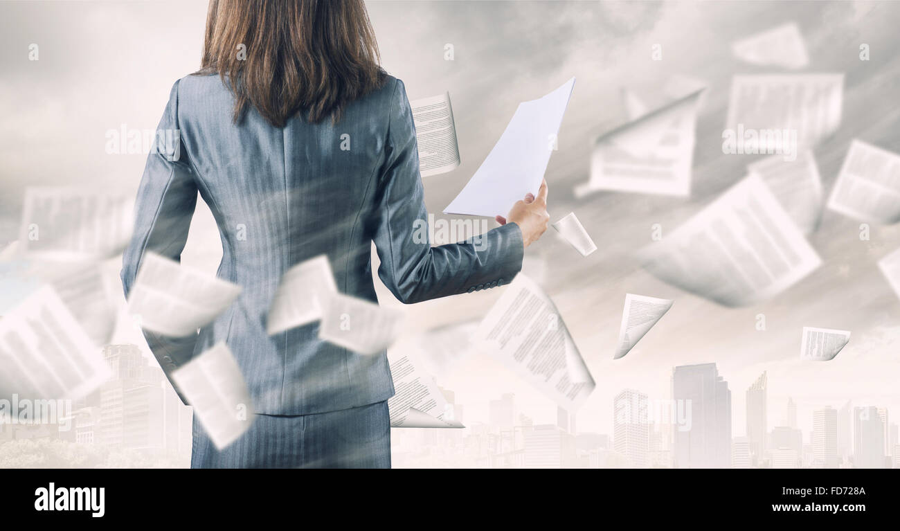 Back view of businesswoman holding papers in hands Stock Photo - Alamy