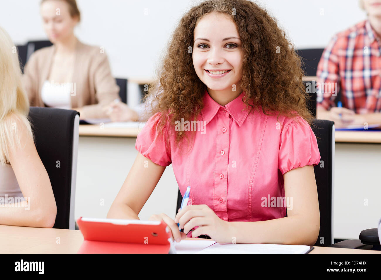 Young people sitting in classroom at lesson Stock Photo - Alamy