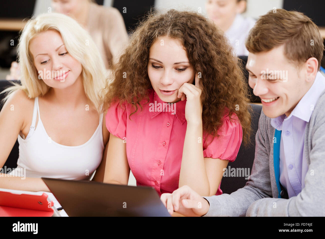 Young people sitting in classroom at lesson Stock Photo - Alamy