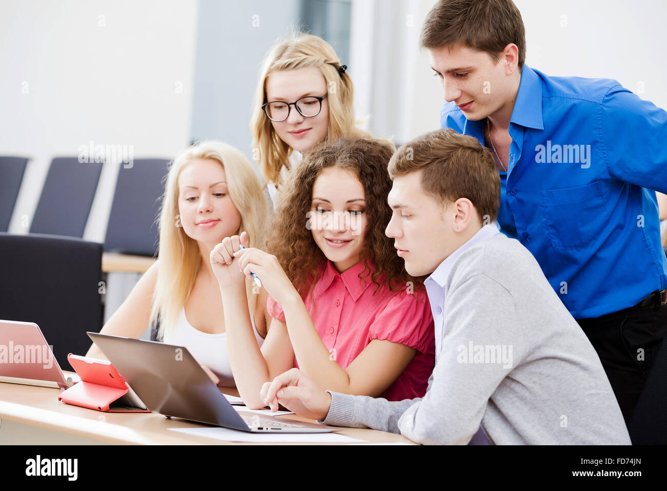 Young people sitting in classroom at lesson Stock Photo - Alamy