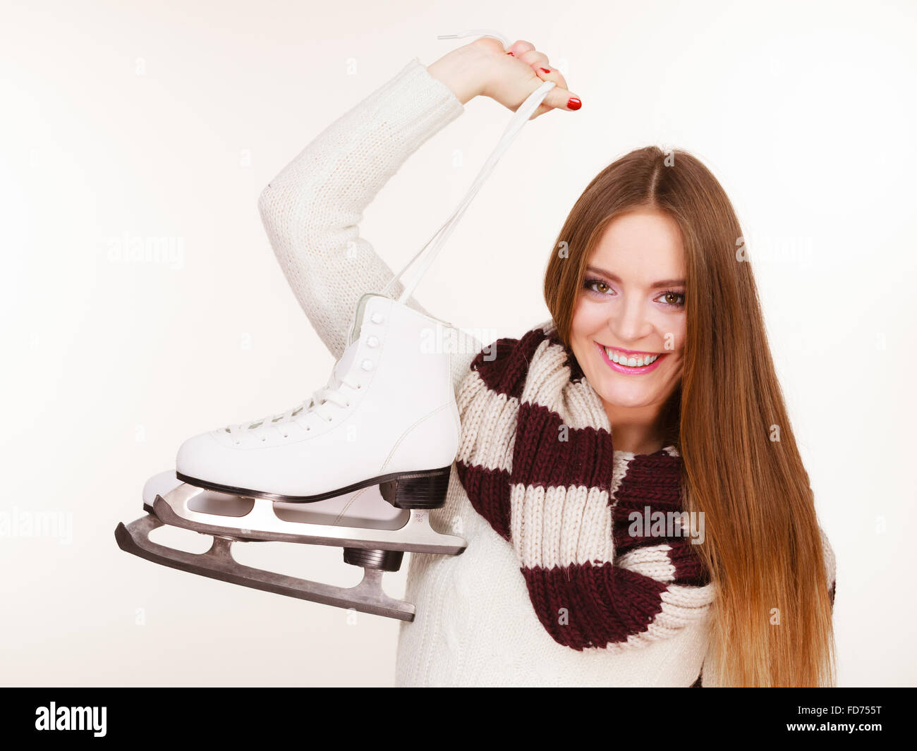 Woman with ice skates getting ready for ice skating, winter sport ...
