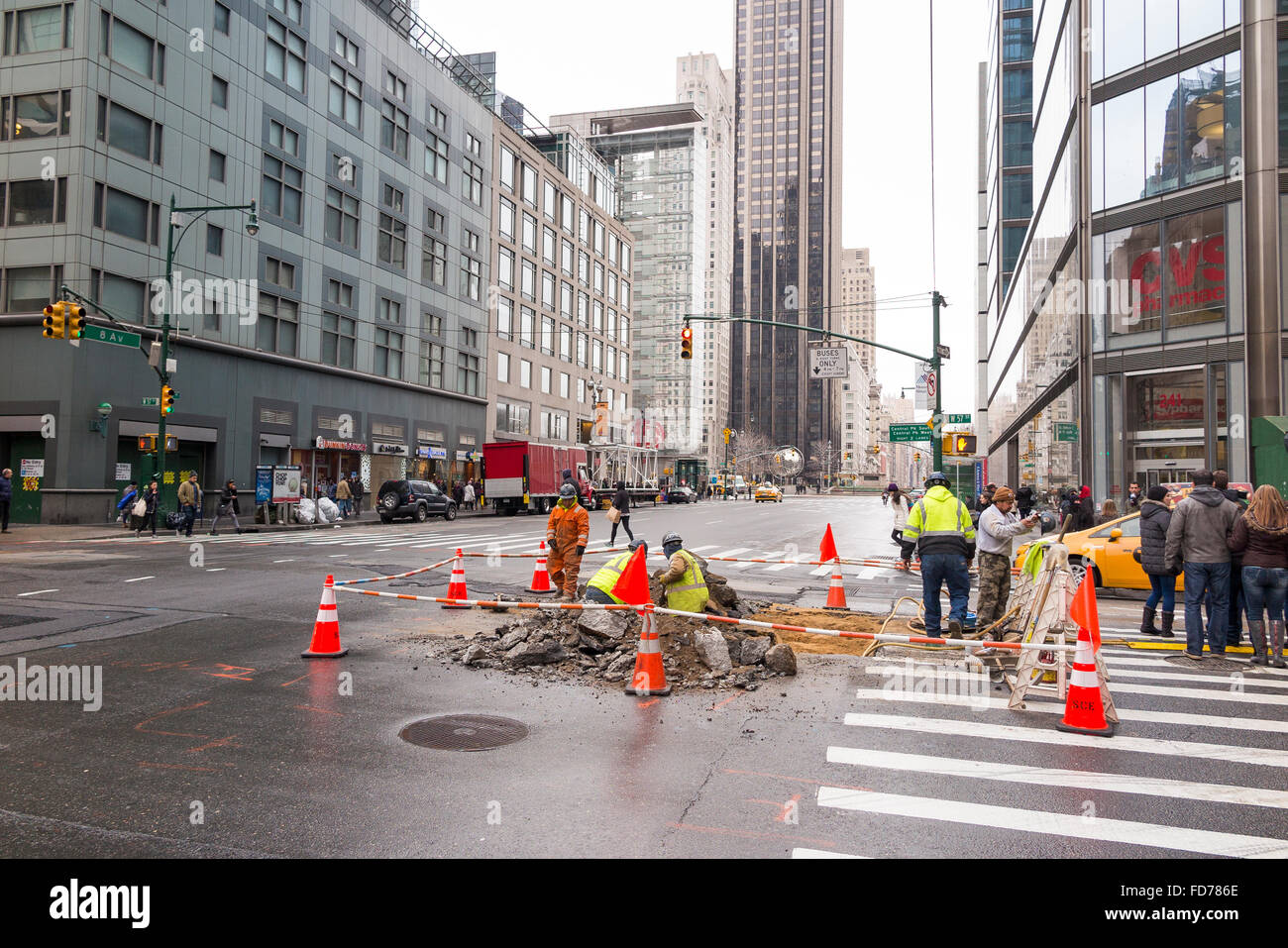 Public workers digging a hole on the street of New York City to perform ...