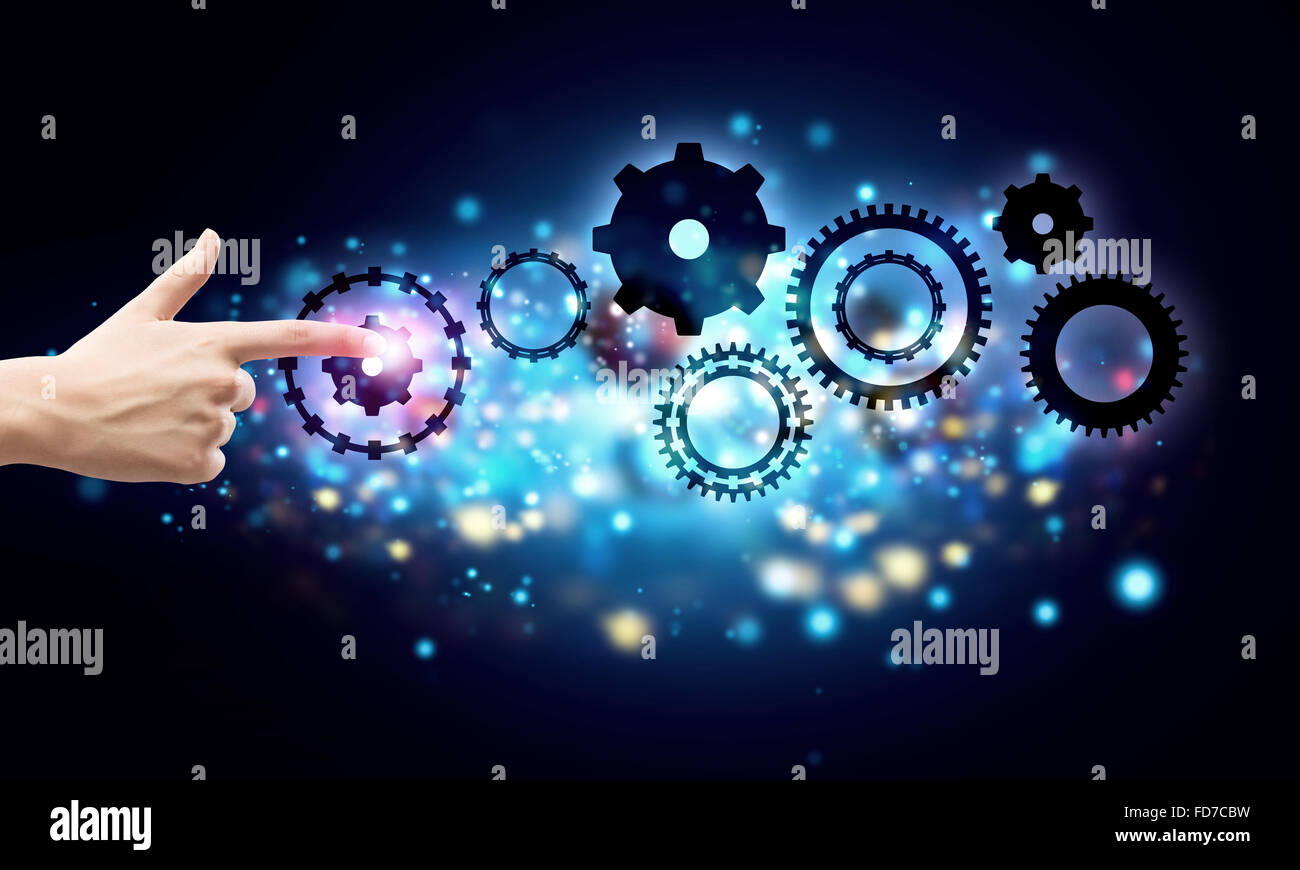 Close up of hand touching icon of gears on media screen Stock Photo - Alamy