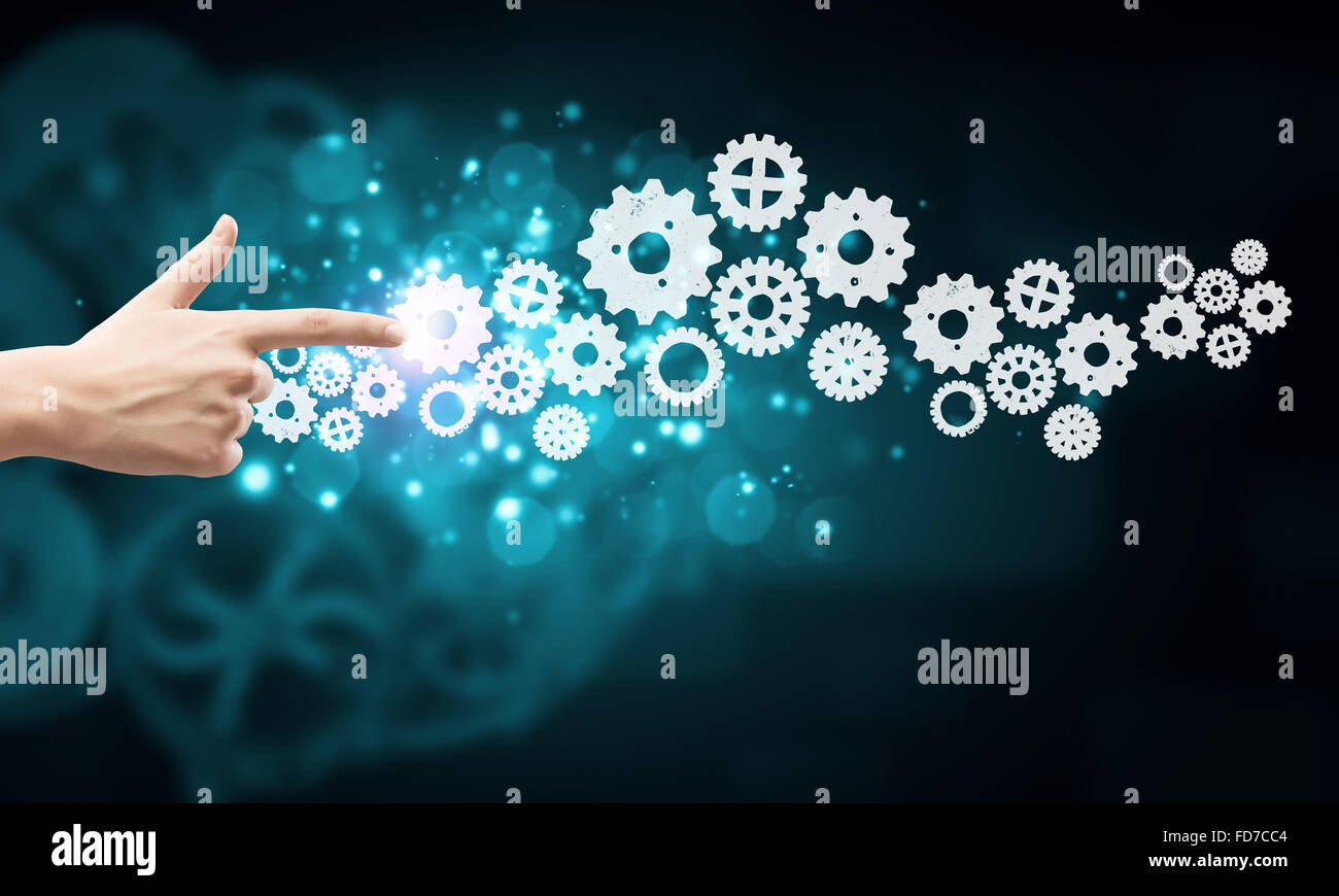 Close up of hand touching icon of gears on media screen Stock Photo - Alamy