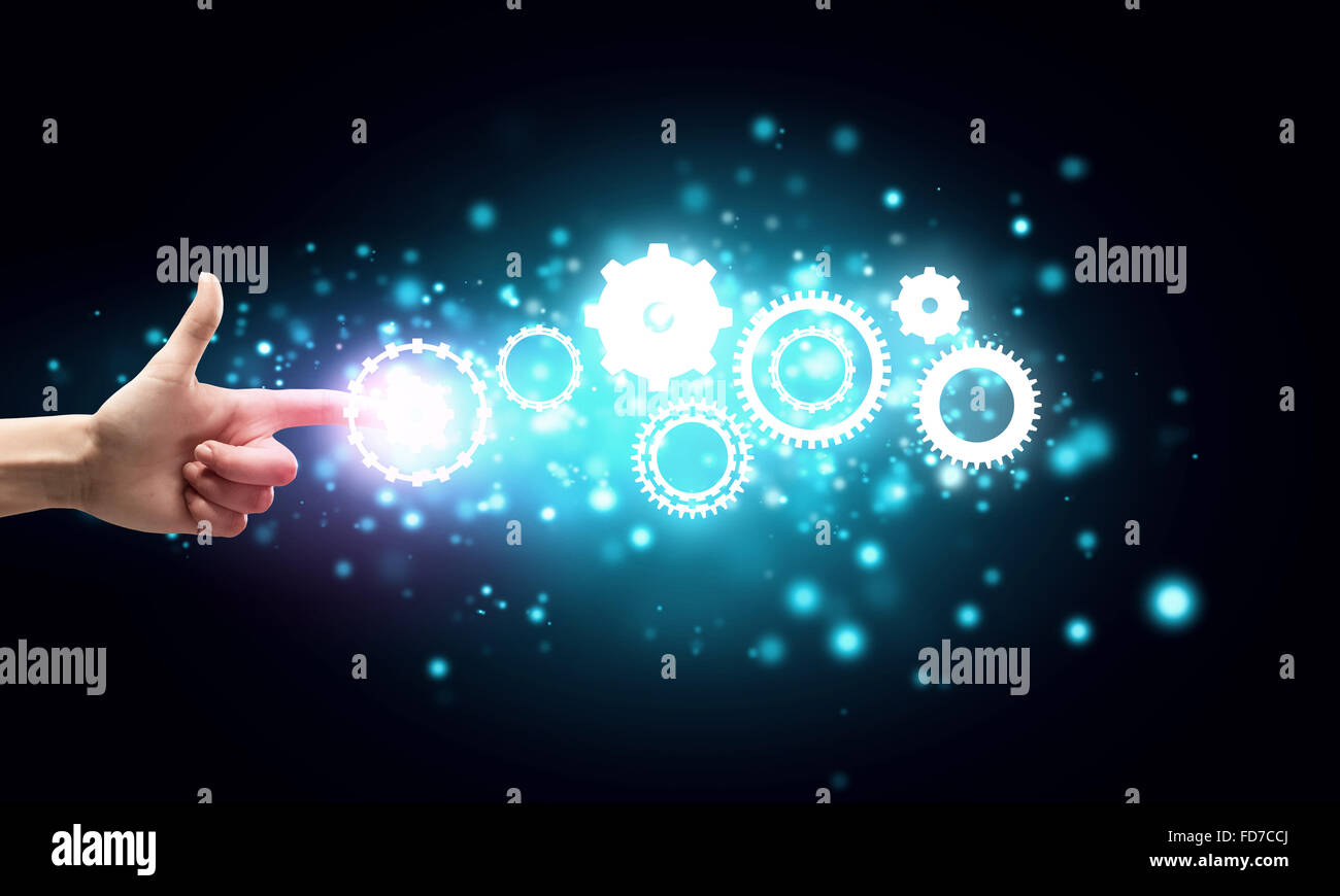 Close up of hand touching icon of gears on media screen Stock Photo - Alamy