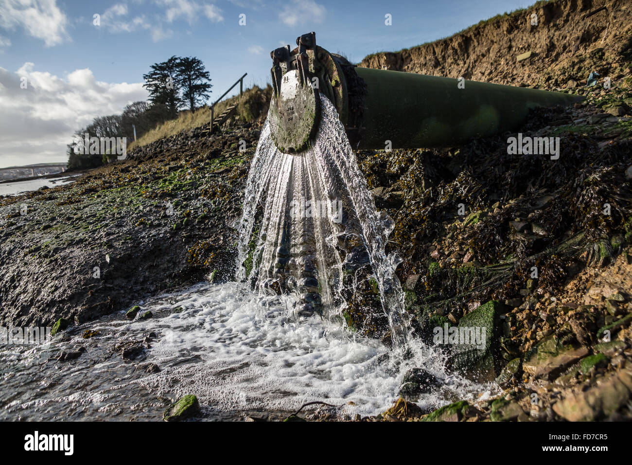Waste water flows out of an outflow waste water pipe into the river in ...