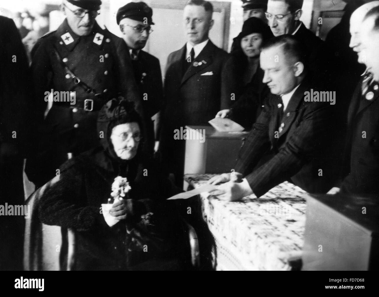 A hundred-year-old woman from Danzig votes aboard the 'Preussen' in the ...