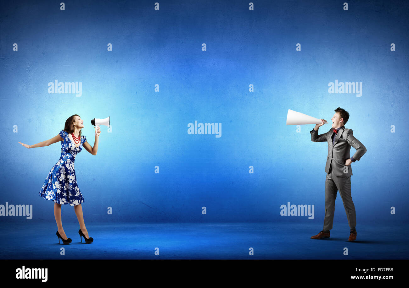 Two business people shouting in megaphones at each other Stock Photo ...
