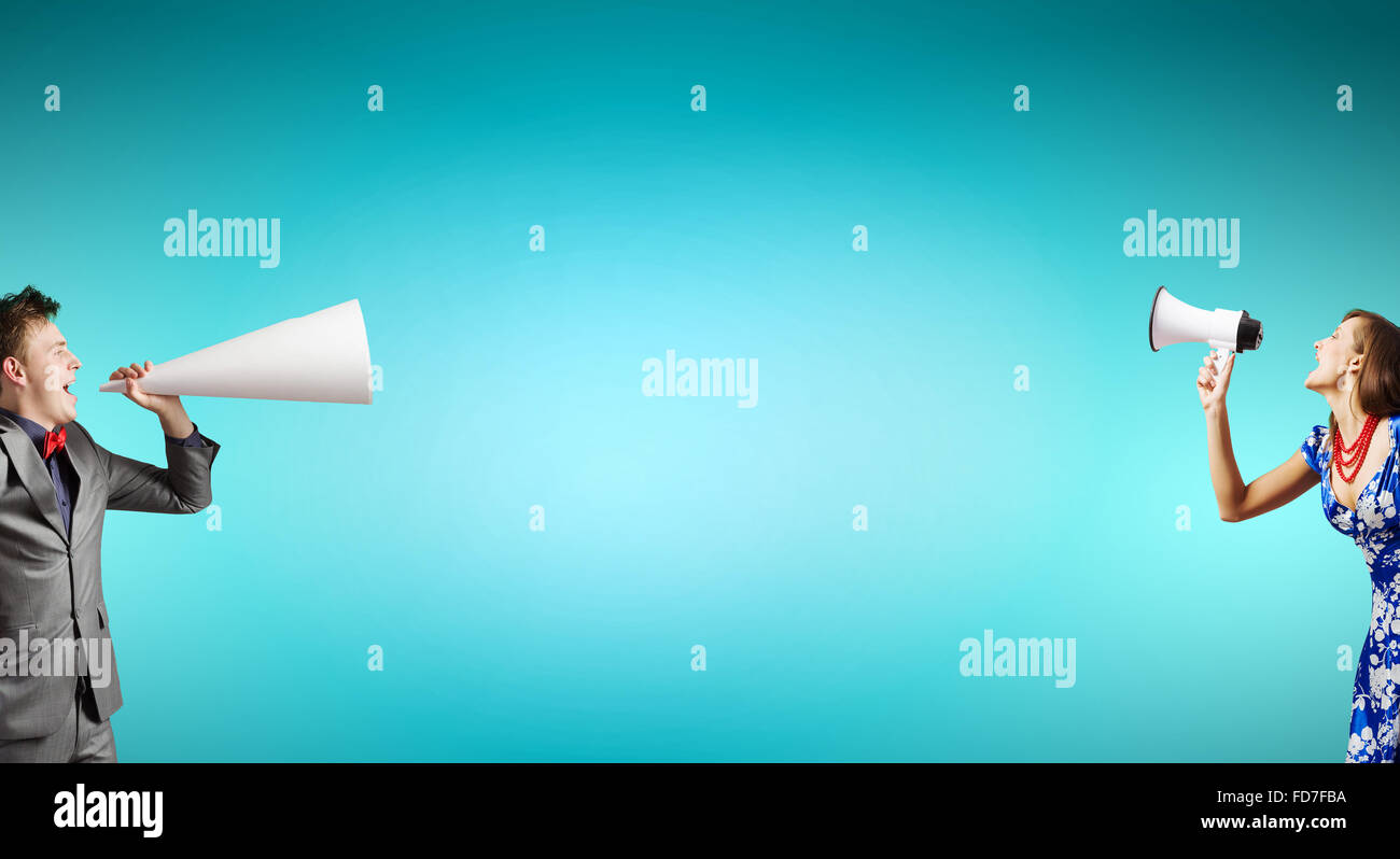 Two business people shouting in megaphones at each other Stock Photo ...
