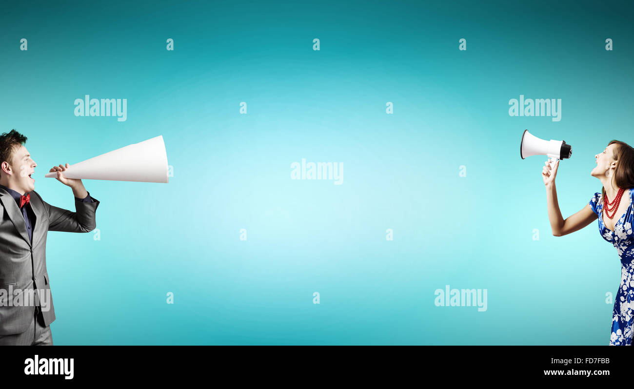 Two business people shouting in megaphones at each other Stock Photo ...