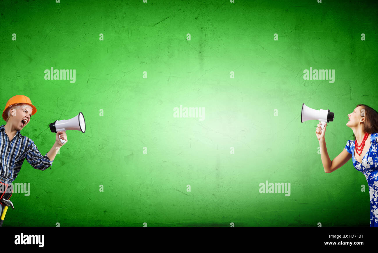 Two business people shouting in megaphones at each other Stock Photo ...