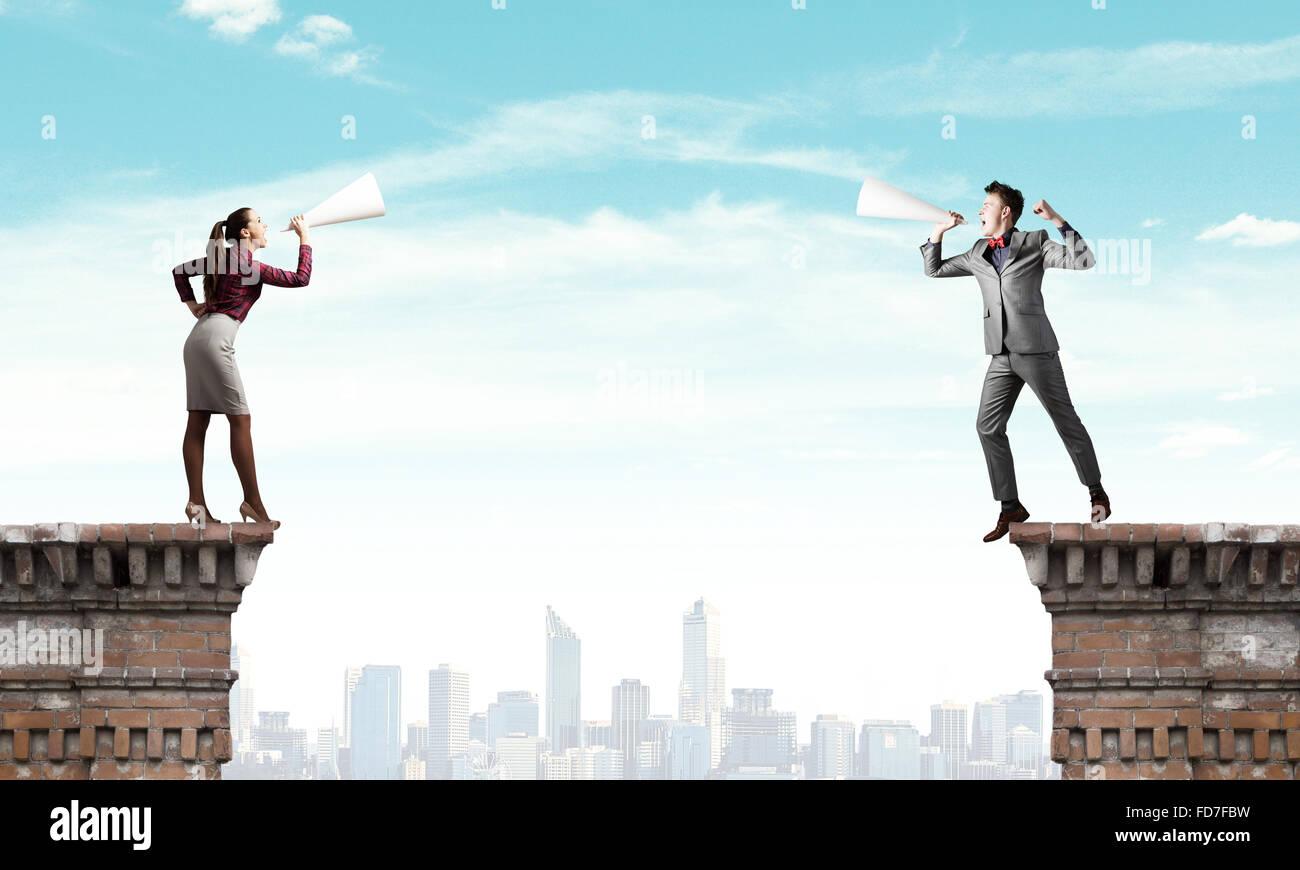 Two business people shouting in megaphones at each other Stock Photo ...