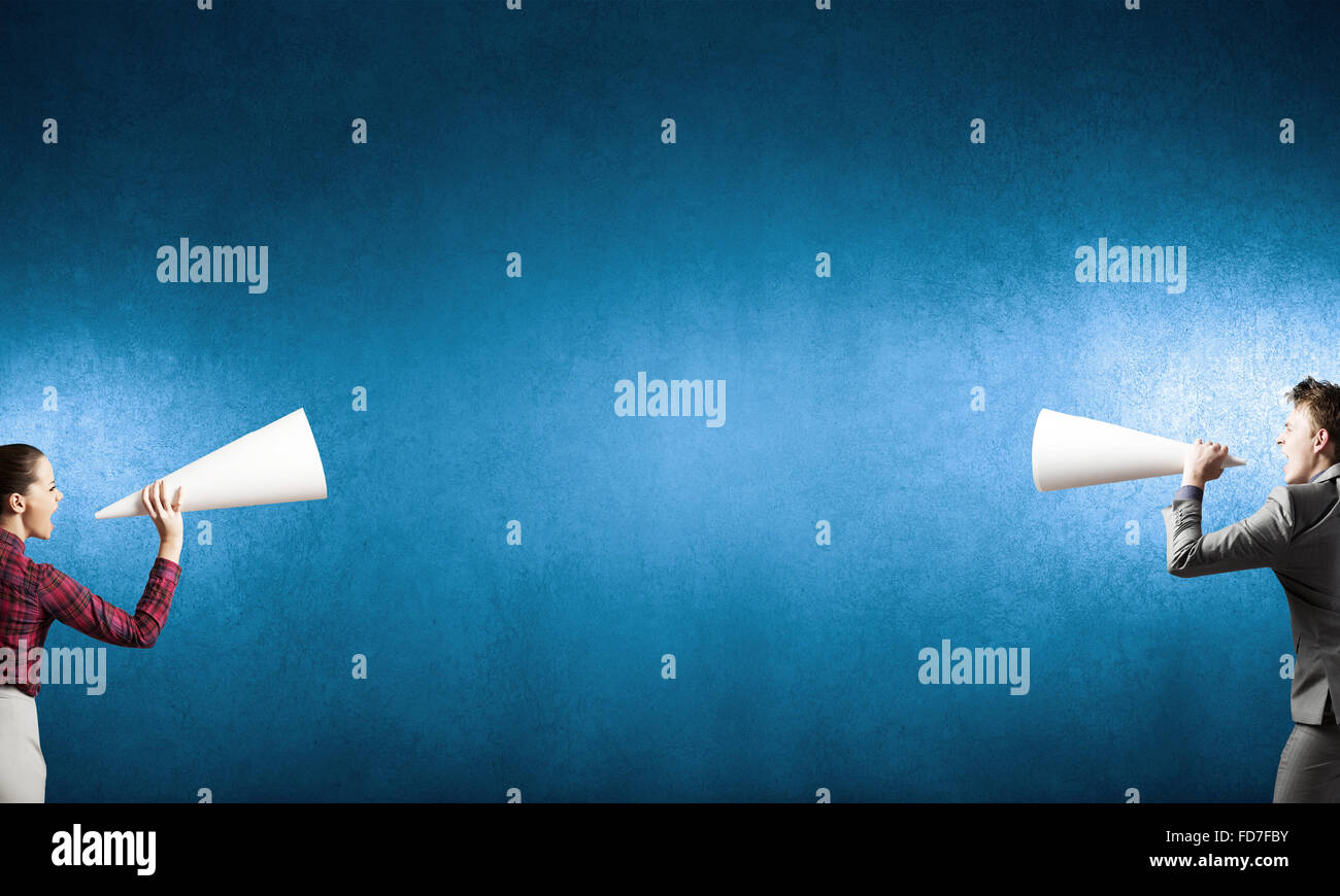 Two business people shouting in megaphones at each other Stock Photo ...