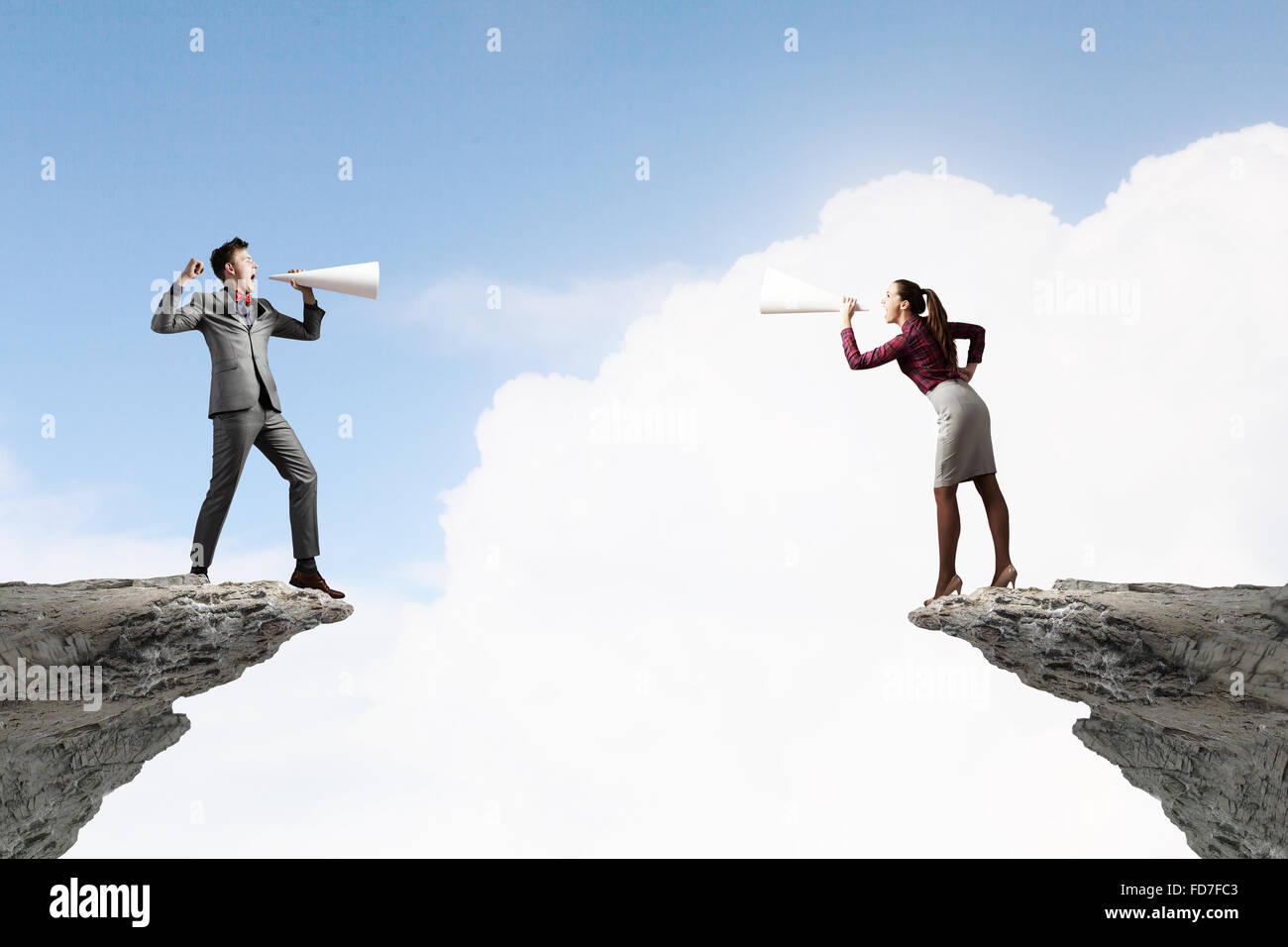 Two business people shouting in megaphones at each other Stock Photo ...