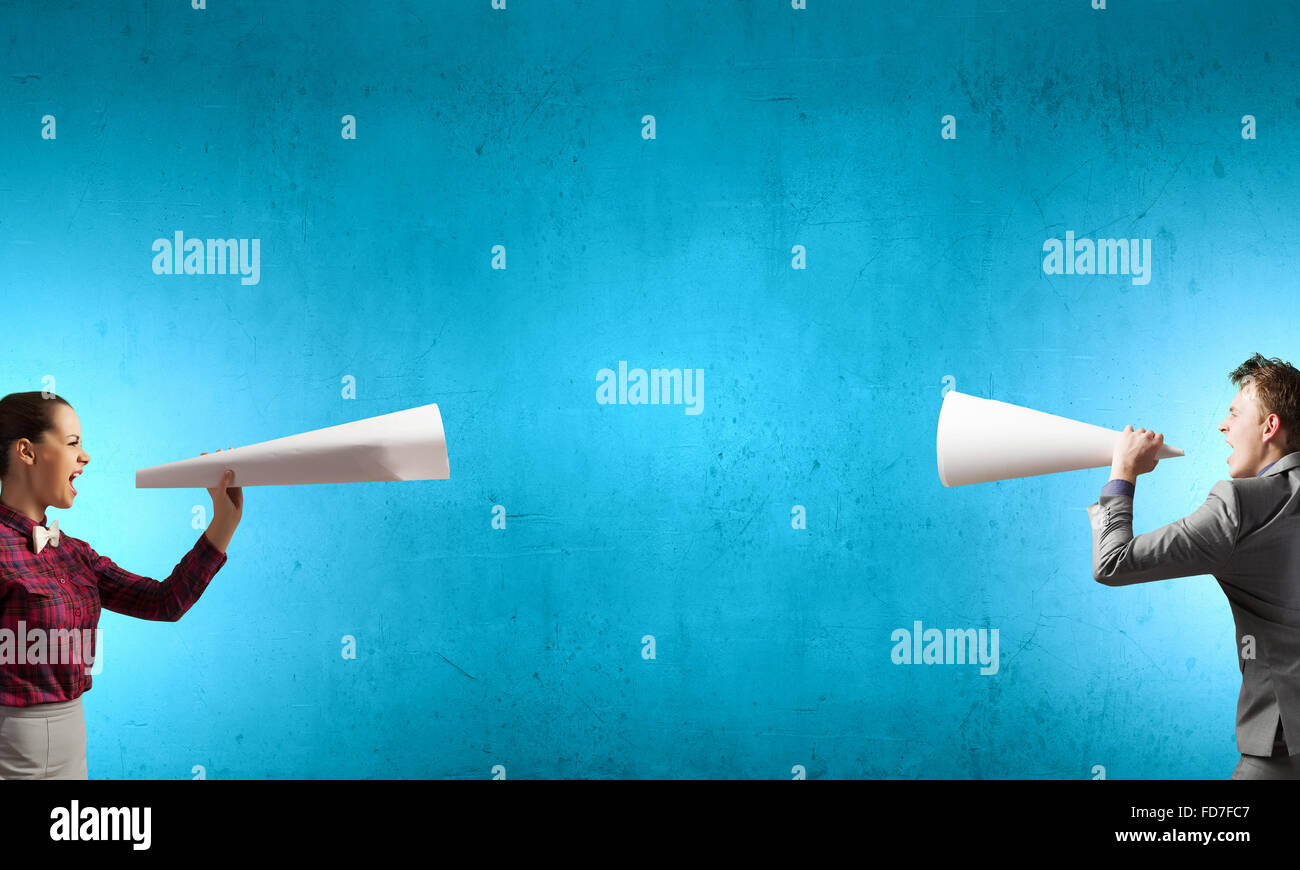 Two business people shouting in megaphones at each other Stock Photo ...