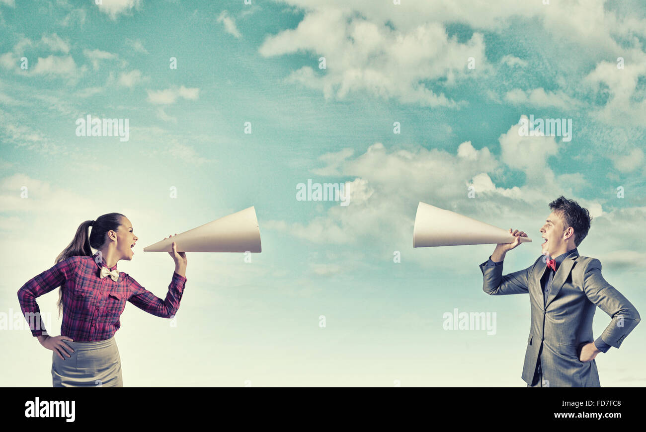 Two business people shouting in megaphones at each other Stock Photo ...