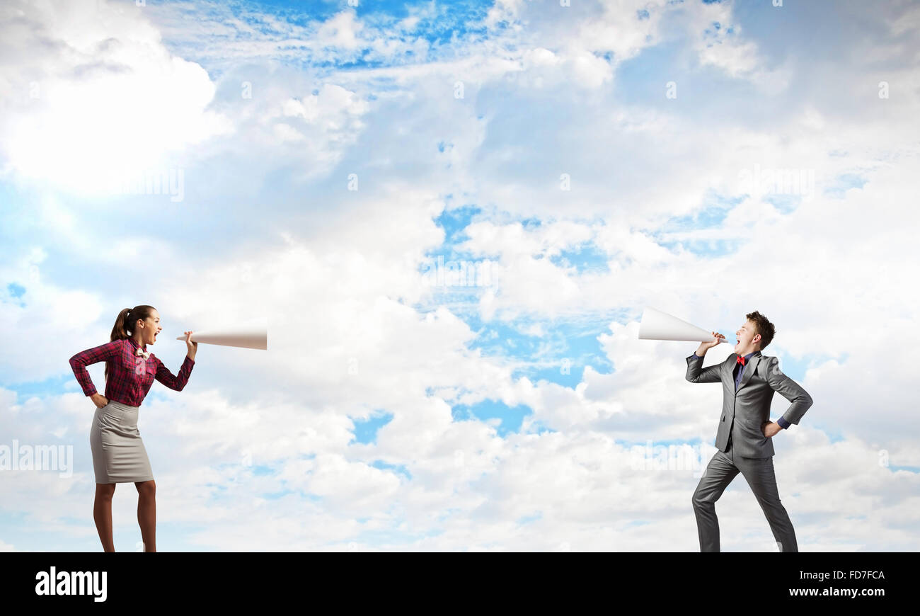 Two business people shouting in megaphones at each other Stock Photo ...