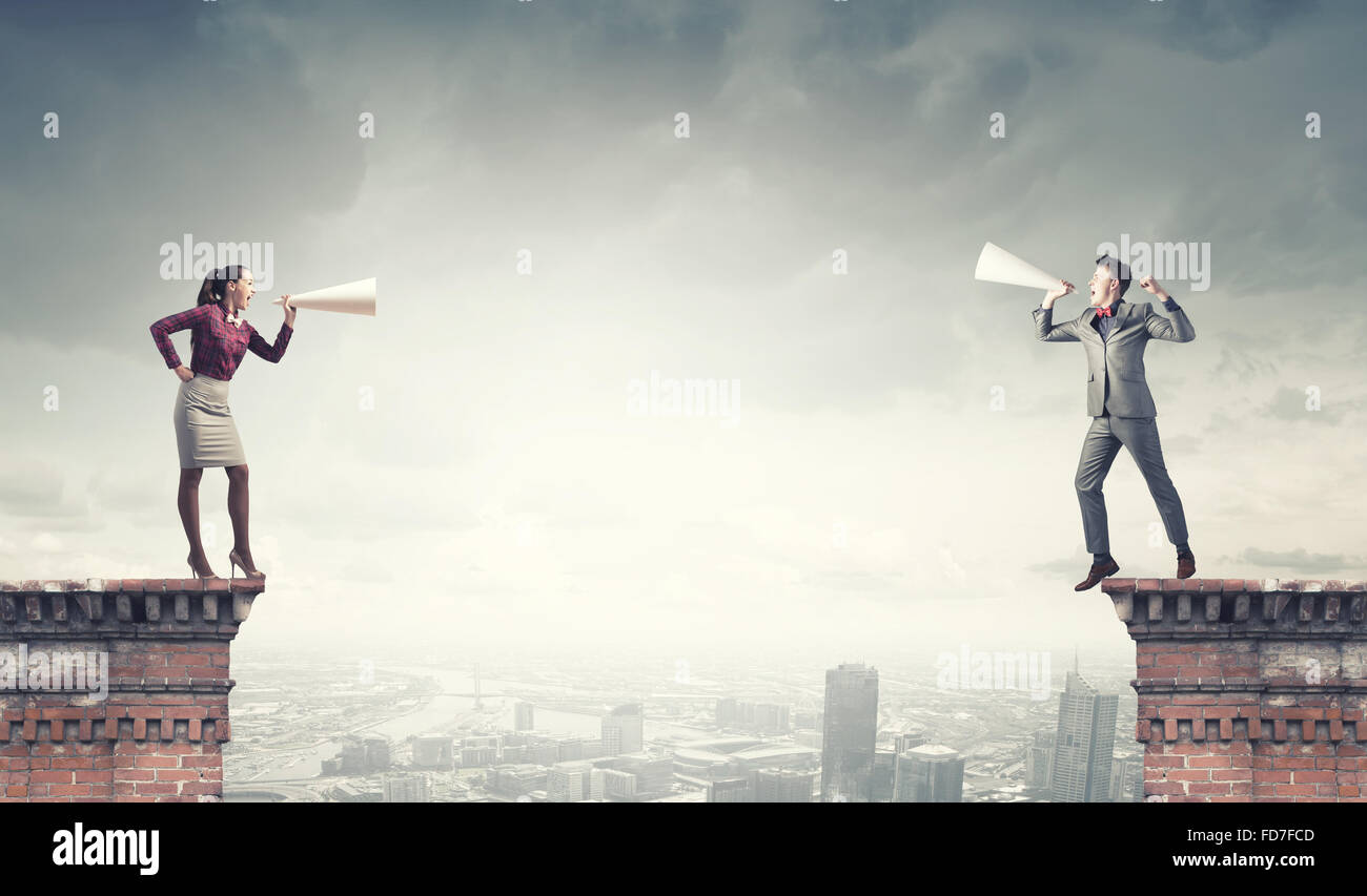 Two business people shouting in megaphones at each other Stock Photo ...