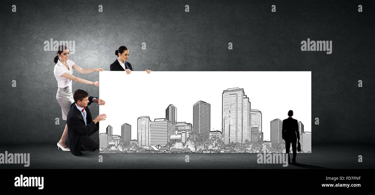 Small group of business people holding banner with construction project ...