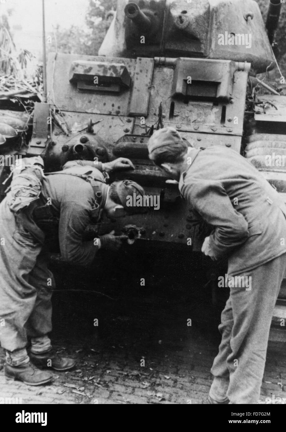 Wehrmacht soldiers inspect a destroyed tank, 1944 Stock Photo - Alamy
