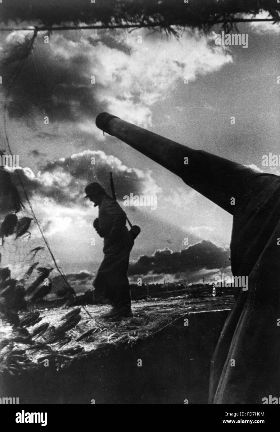 German sentry in front of coastal artillery gun on the Channel coast ...